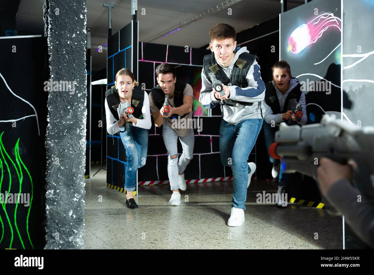 Young people having fun on lasertag arena Stock Photo - Alamy