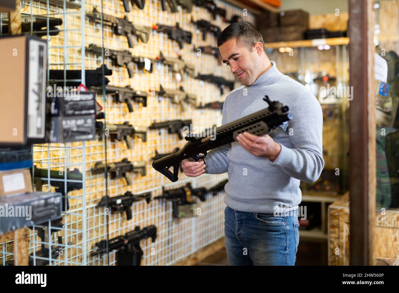 Caucasian man in airsoft shop Stock Photo - Alamy