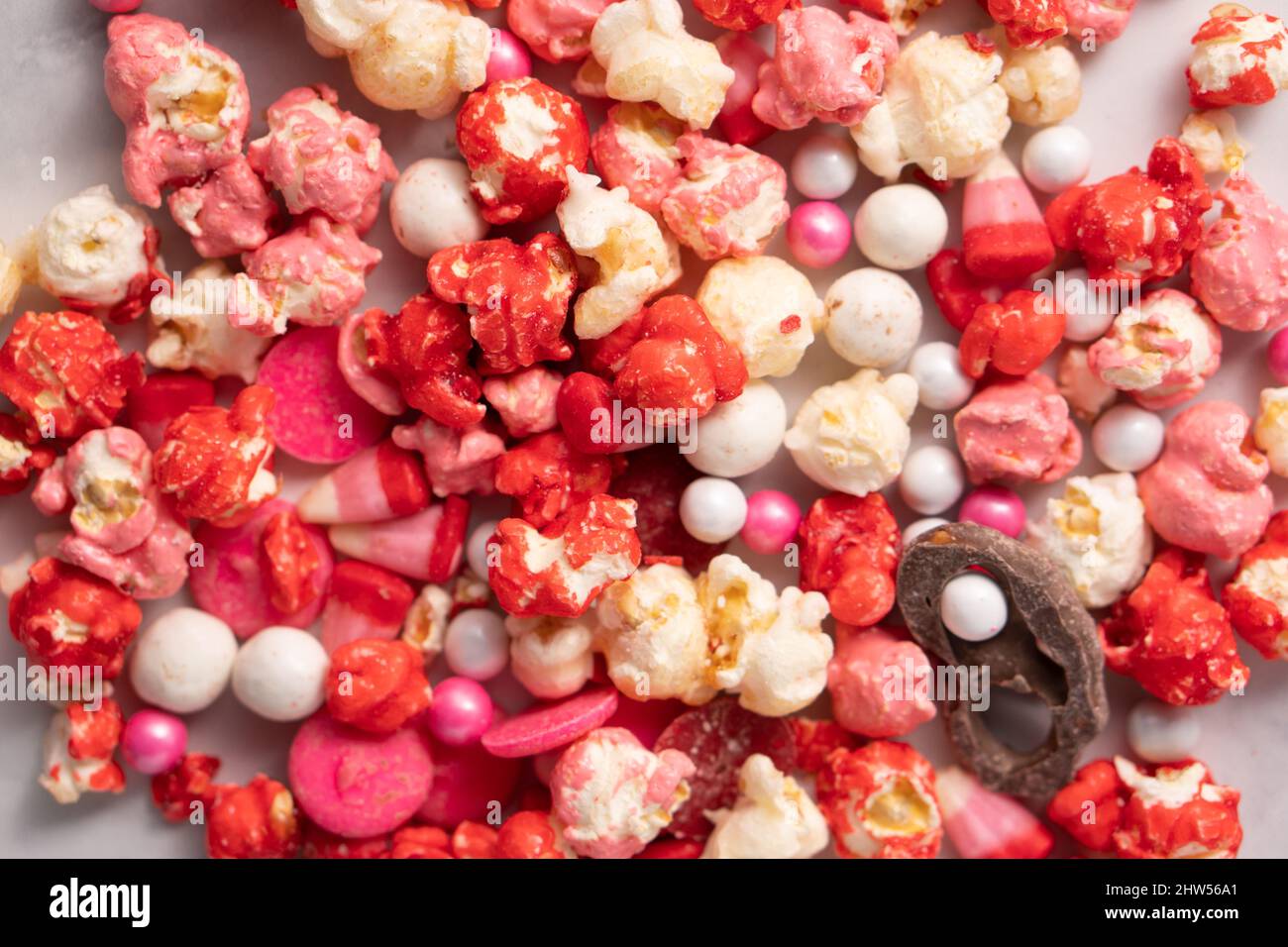 Colorful red and pink candied popcorn with mixed candies pile Stock ...