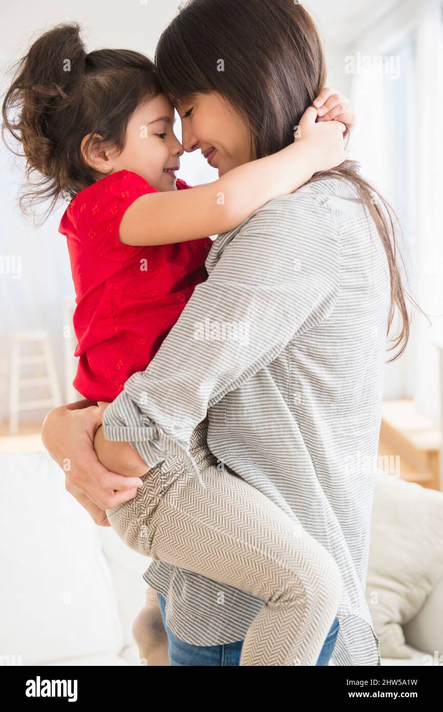 Hispanic mother parent daughter girl hugging smiling family hi-res stock photography and images ...