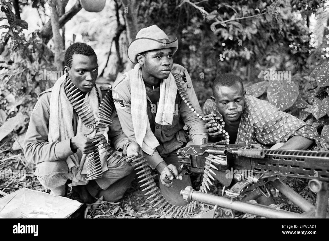Three Biafran soldiers seen here operating a heavy machine gun during the Biafran conlict, 11th ...