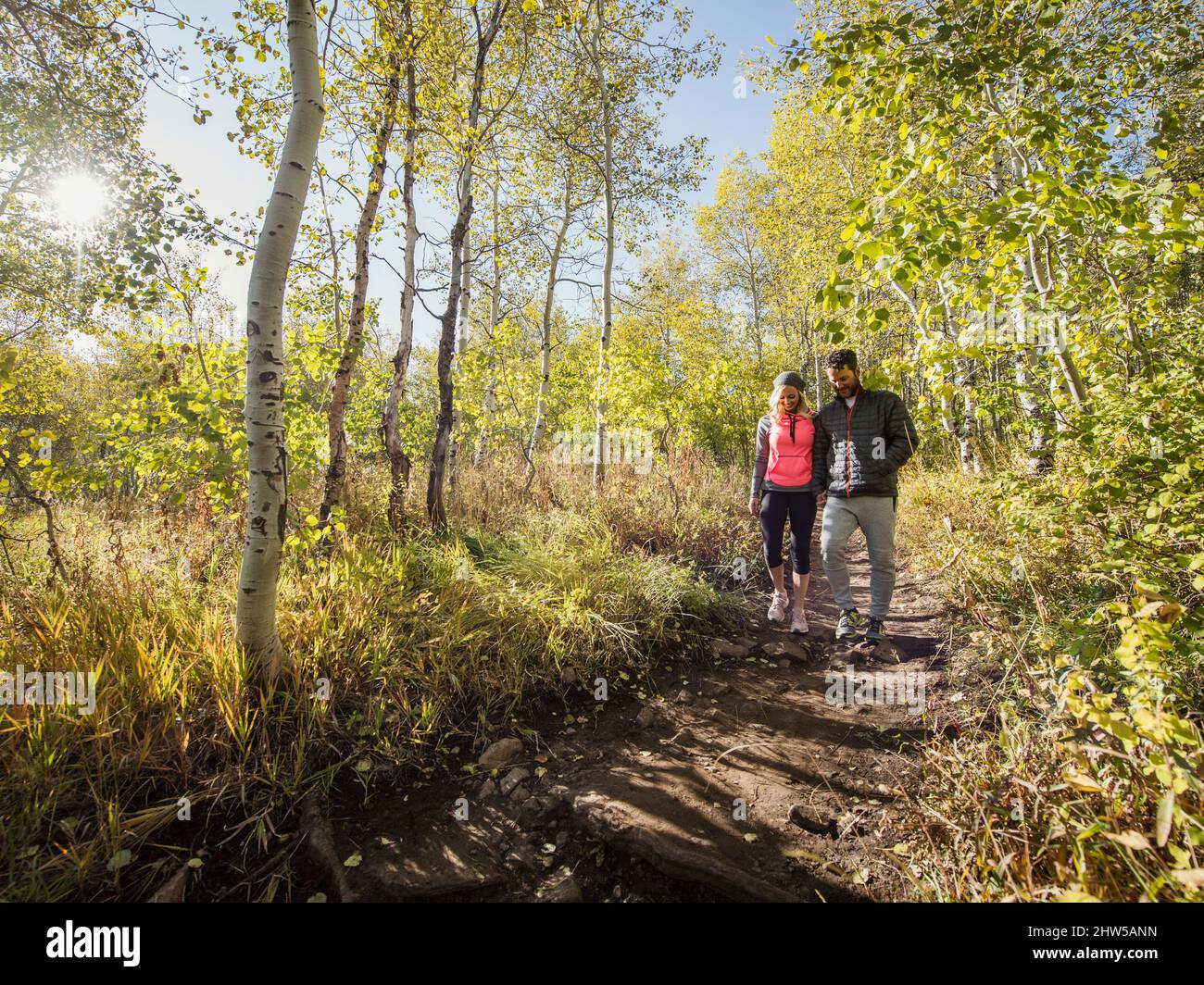 Couple walking in forest Stock Photo - Alamy