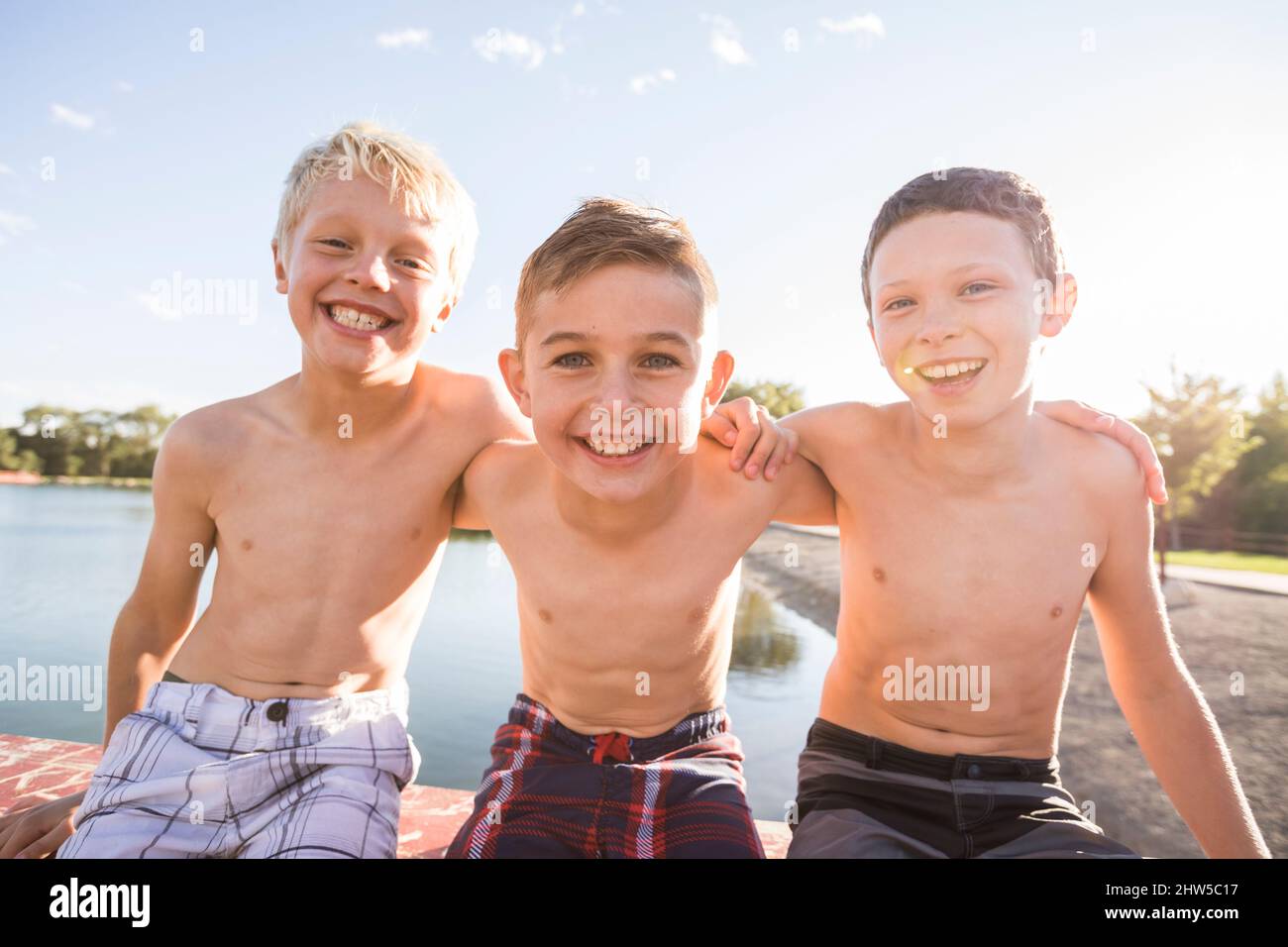 Portrait of smiling shirtless boys (8-9) by river Stock Photo - Alamy