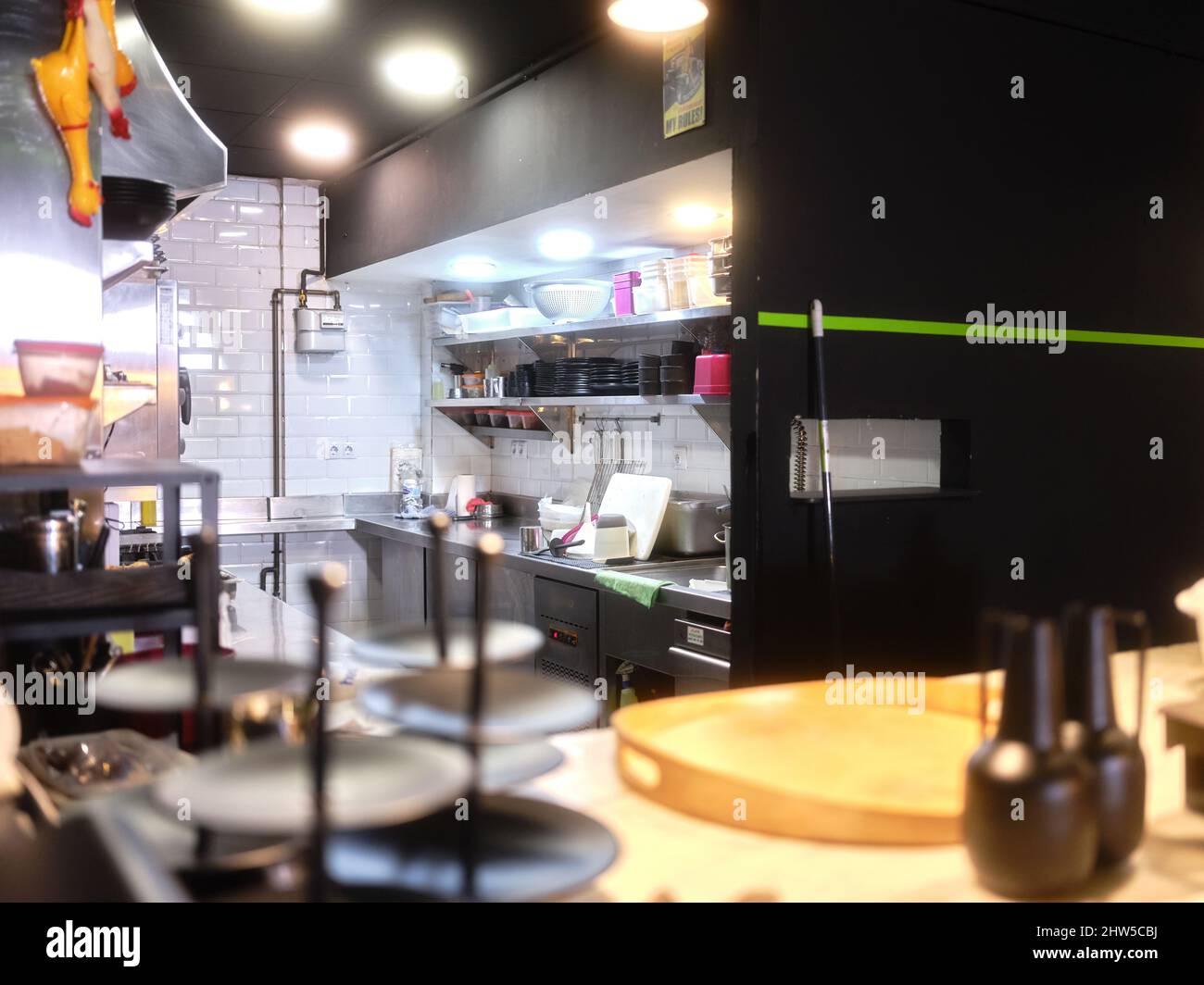 Focus on a restaurant kitchen with plates stacked ready for service ...