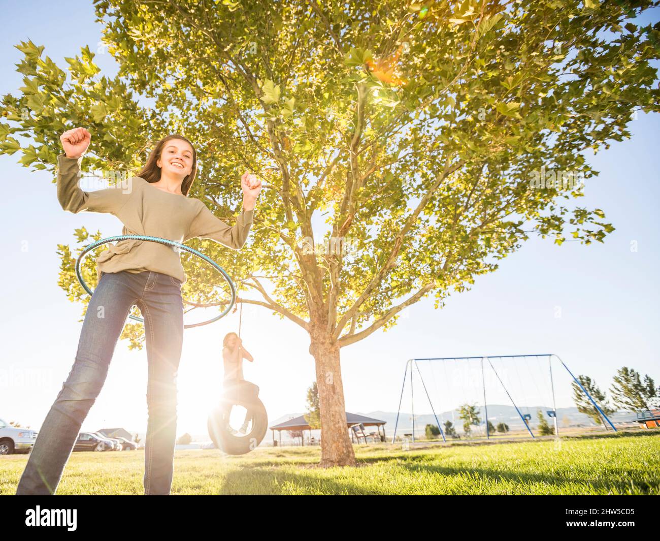 Two girls swinging on hoop hi-res stock photography and images - Alamy