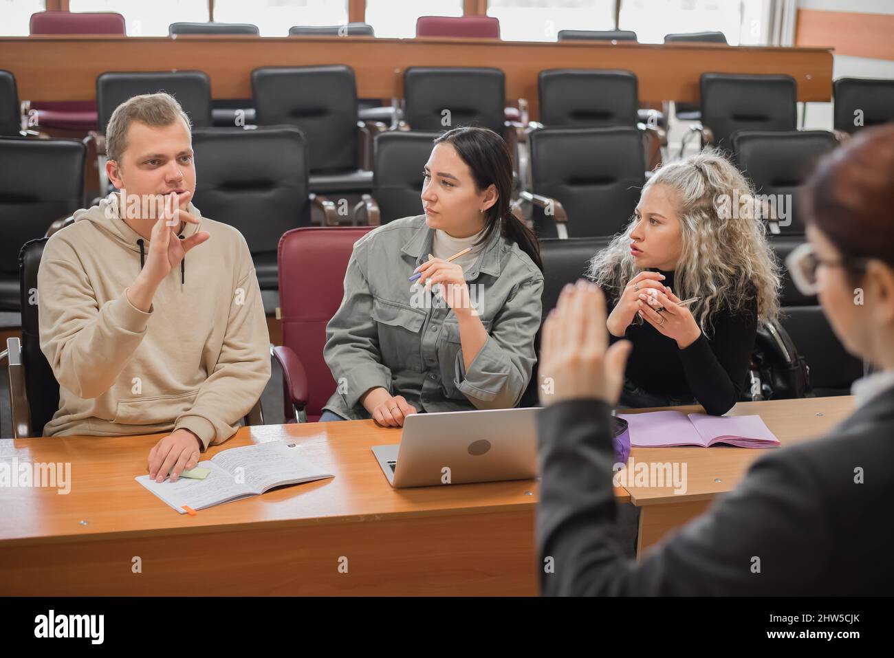 The teacher and students communicate in sign language in the classroom ...
