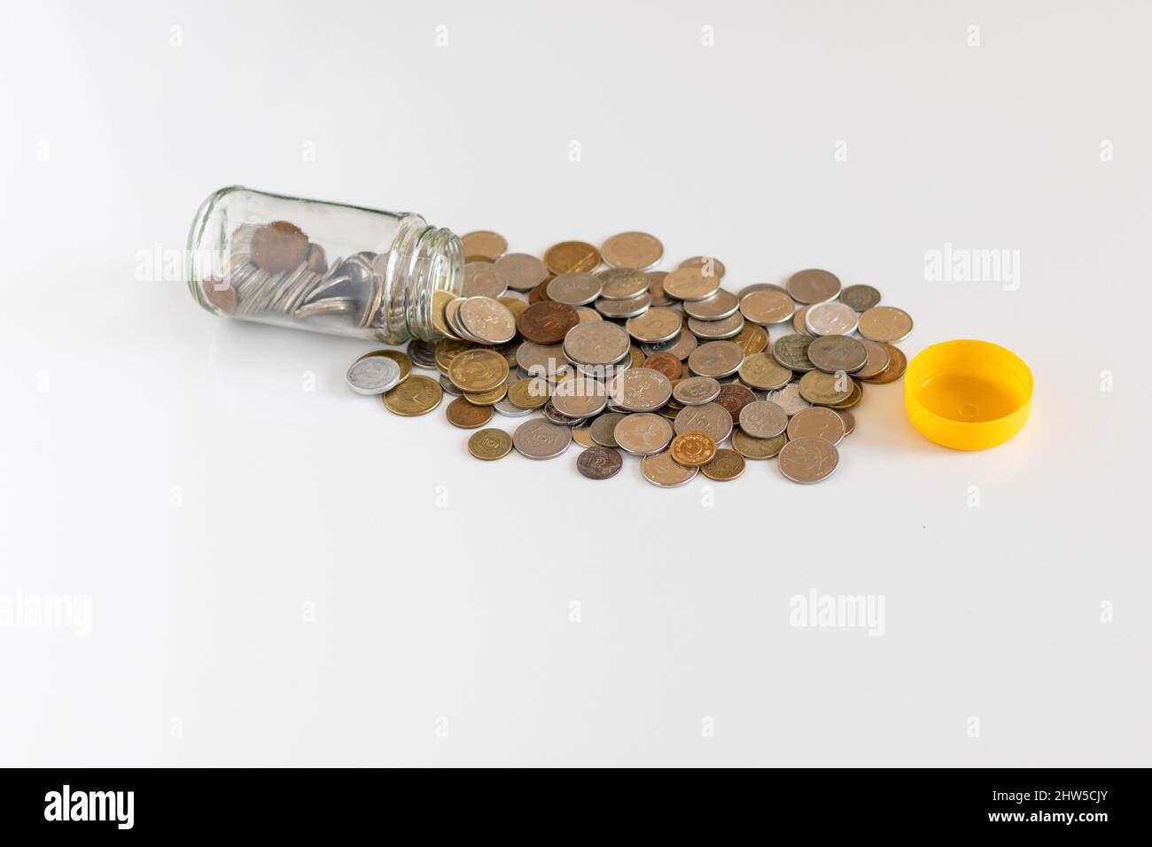 coins with a open glass jar on white isolated background Stock Photo ...