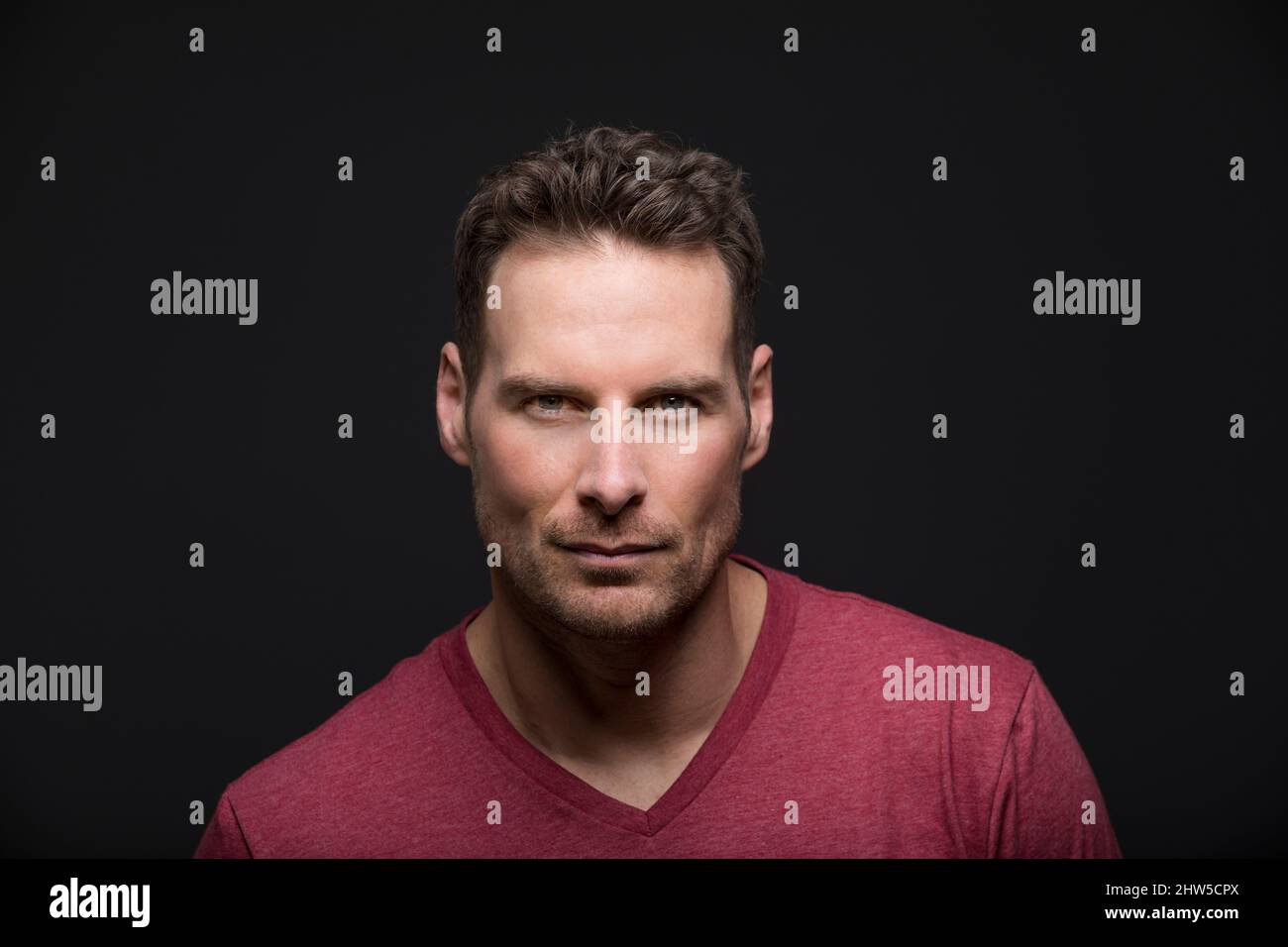 Studio portrait of serious man Stock Photo - Alamy