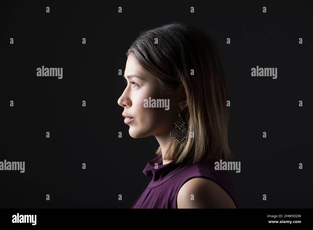 Profile of woman against black background Stock Photo - Alamy