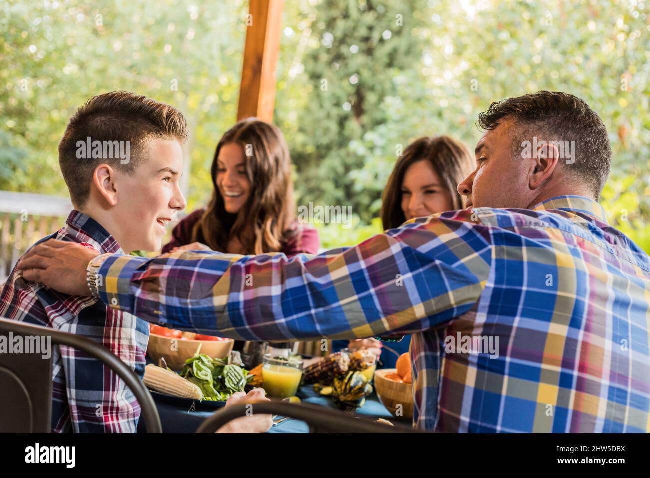 Family with children (10-11, 12-13, 16-17) eating dinner Stock Photo ...
