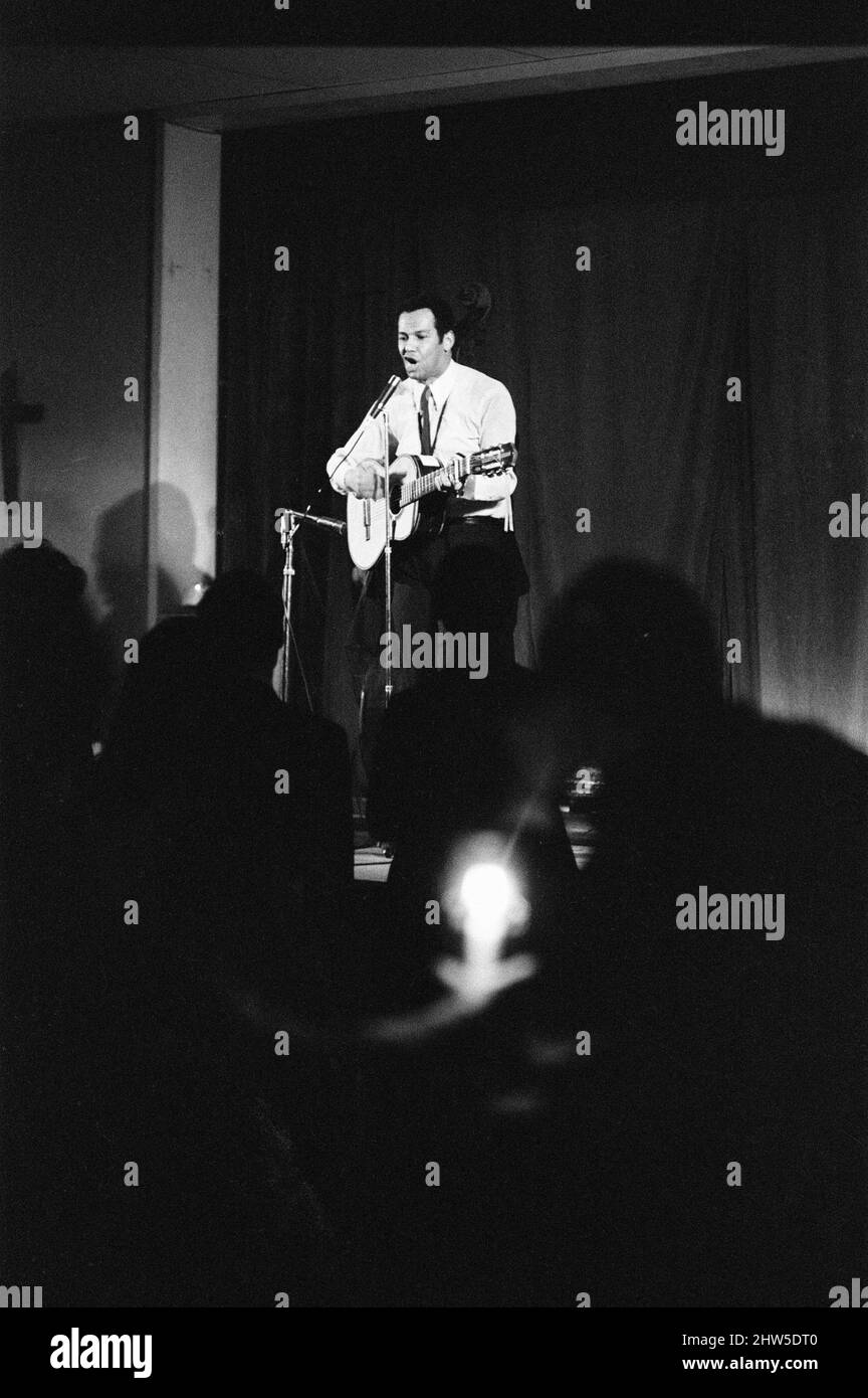 Cy Grant performs at a folk singing club in a Methodist Church, Kings ...