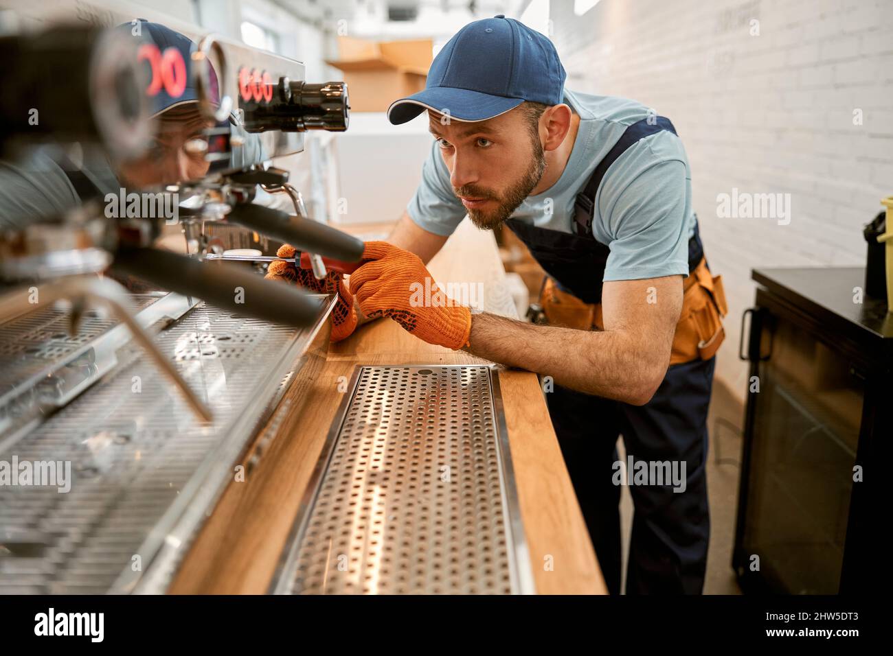 Repairman fixing professional coffee machine in cafe Stock Photo - Alamy
