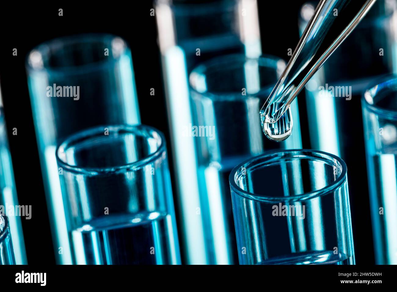 Pipette dropping liquid into test tube Stock Photo - Alamy