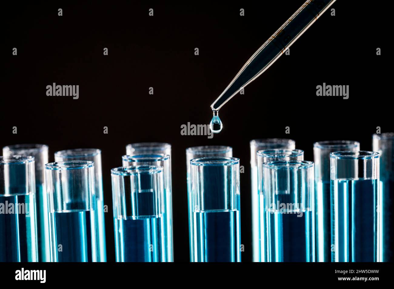 Pipette dropping liquid into test tube Stock Photo - Alamy