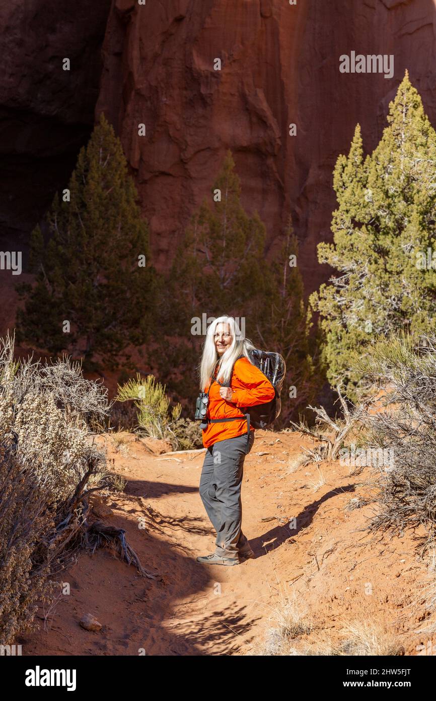 United States, Utah, Escalante, Senior female hiker exploring canyon ...