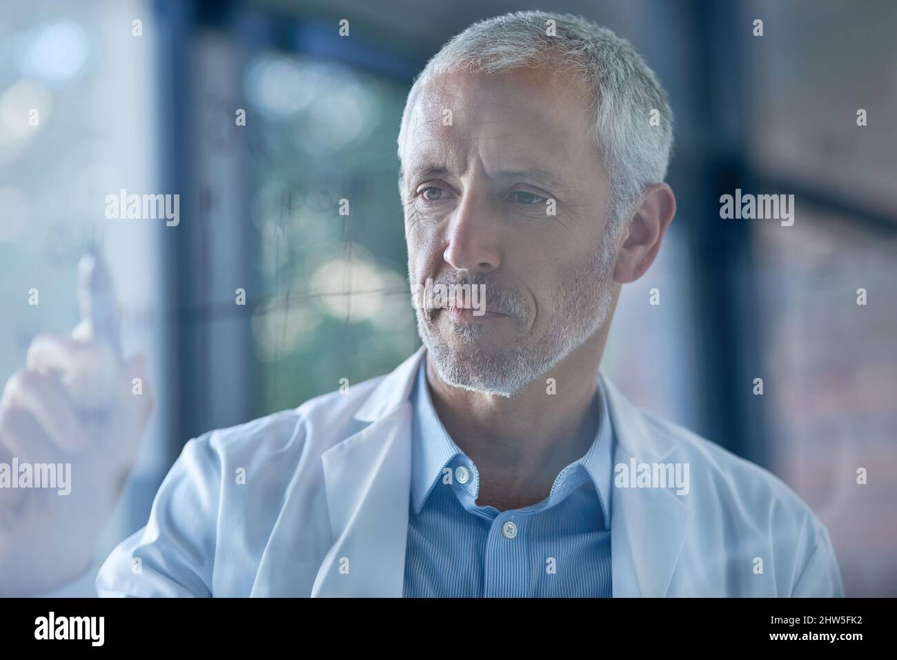 Finding accuracy in his analysis. Cropped shot of a male scientist ...