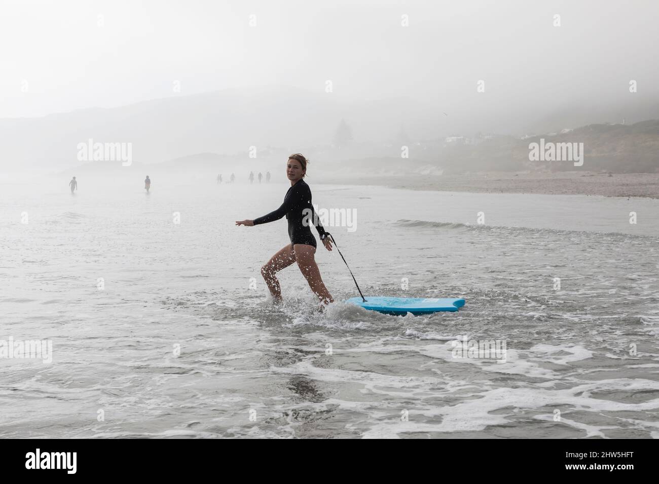 Girl (16-17) bodyboarding on Grotto Beach Stock Photo - Alamy
