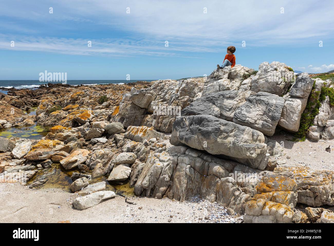 South Africa, Hermanus, Boy (8-9) exploring rocks on Sandbaai Beach Stock Photo - Alamy