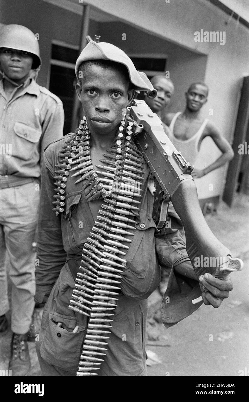 A young Biafran soldier seen here posing with a heavy machine gun and ...