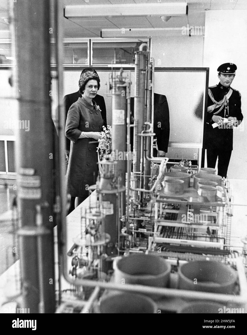 Queen Elizabeth II looks at a model of the new refinery at Milford ...
