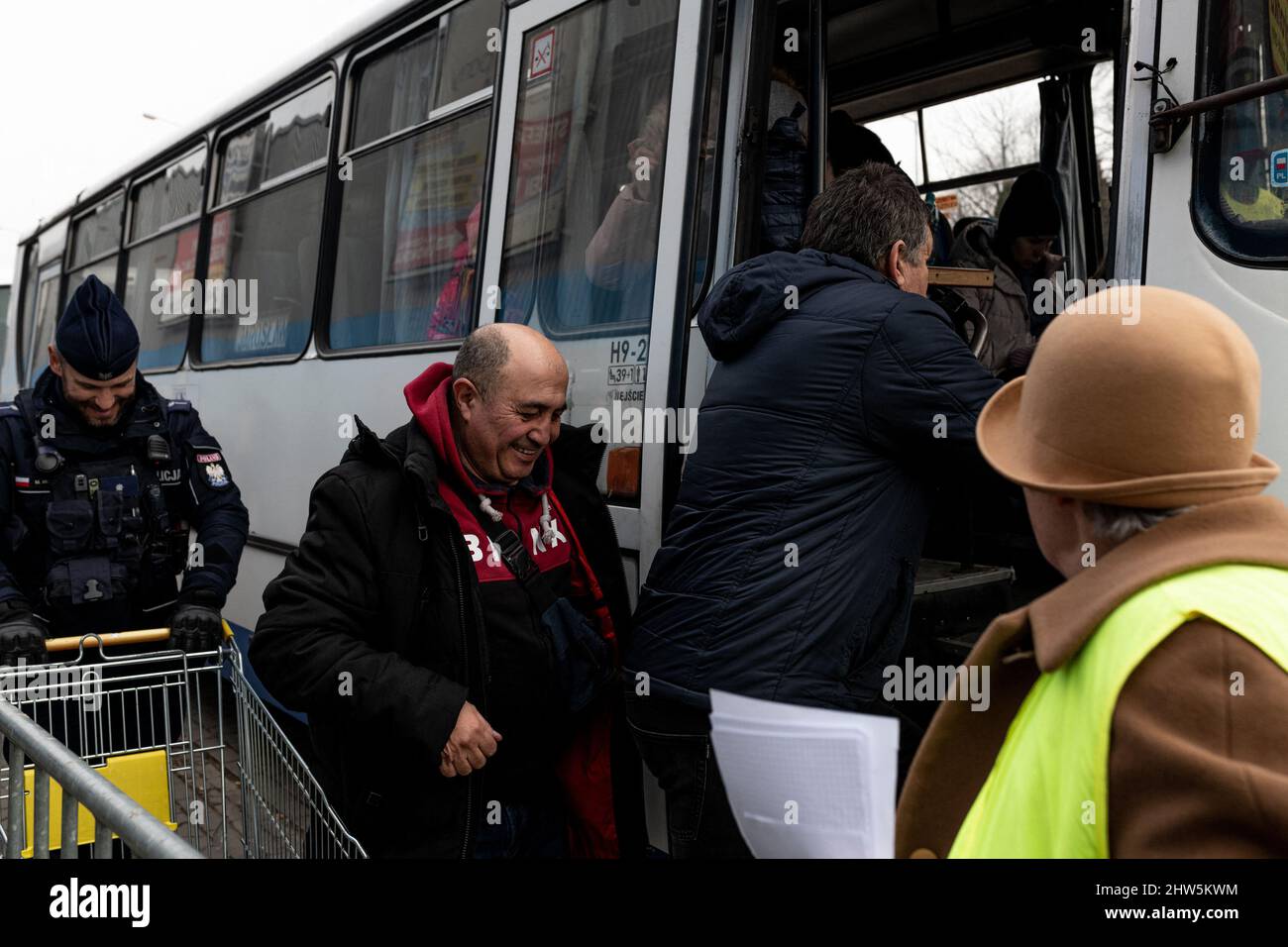 Korczowa, Poland. 03rd Mar, 2022. A man laughs as he prepares to climb ...