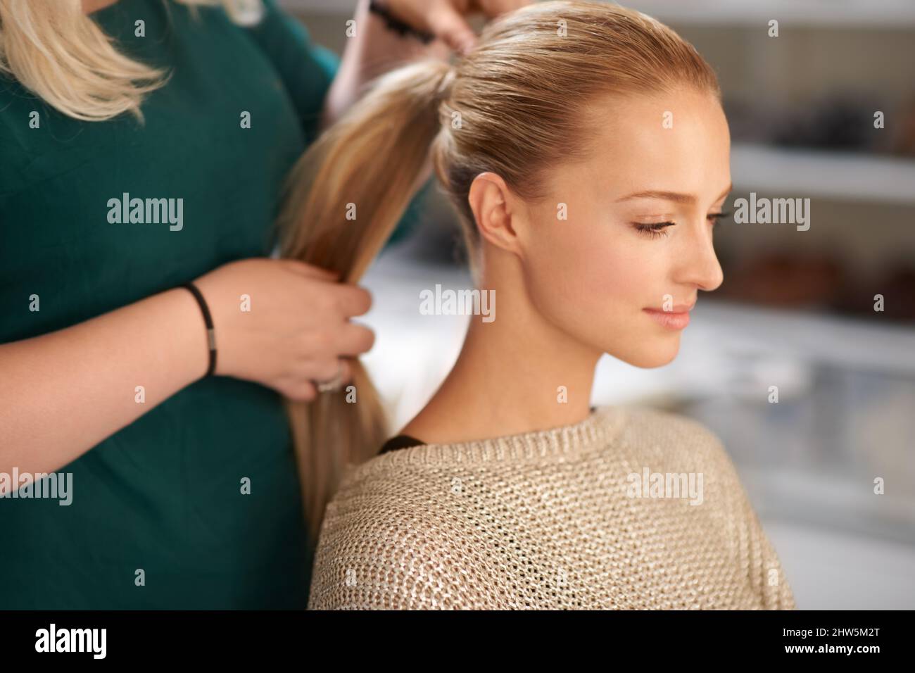 Finding that perfect hairdo. A young woman getting her hair done Stock ...