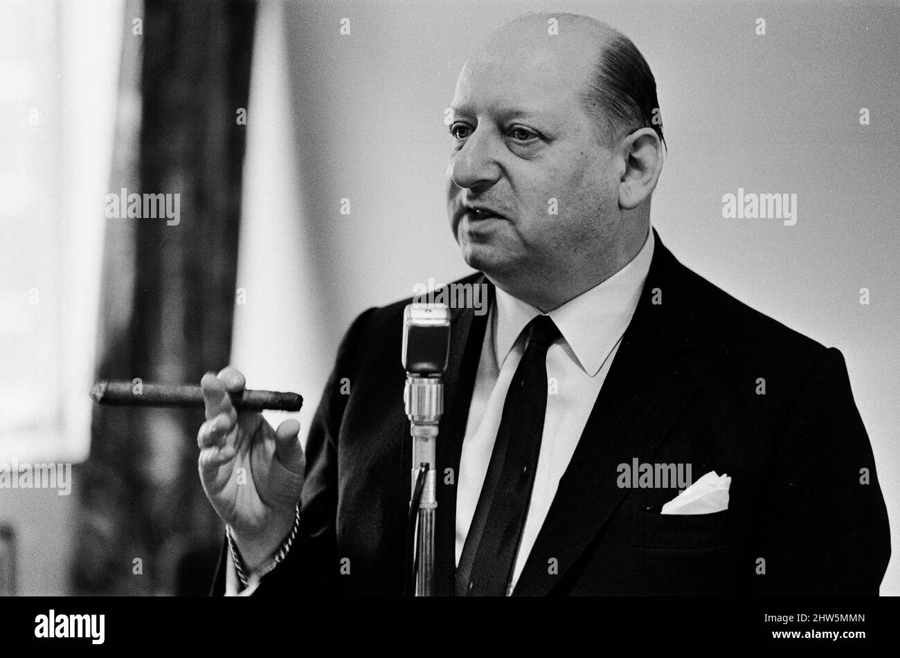 Media Mogul Lord Lew Grade makes a speech at a dinner party, holding a ...