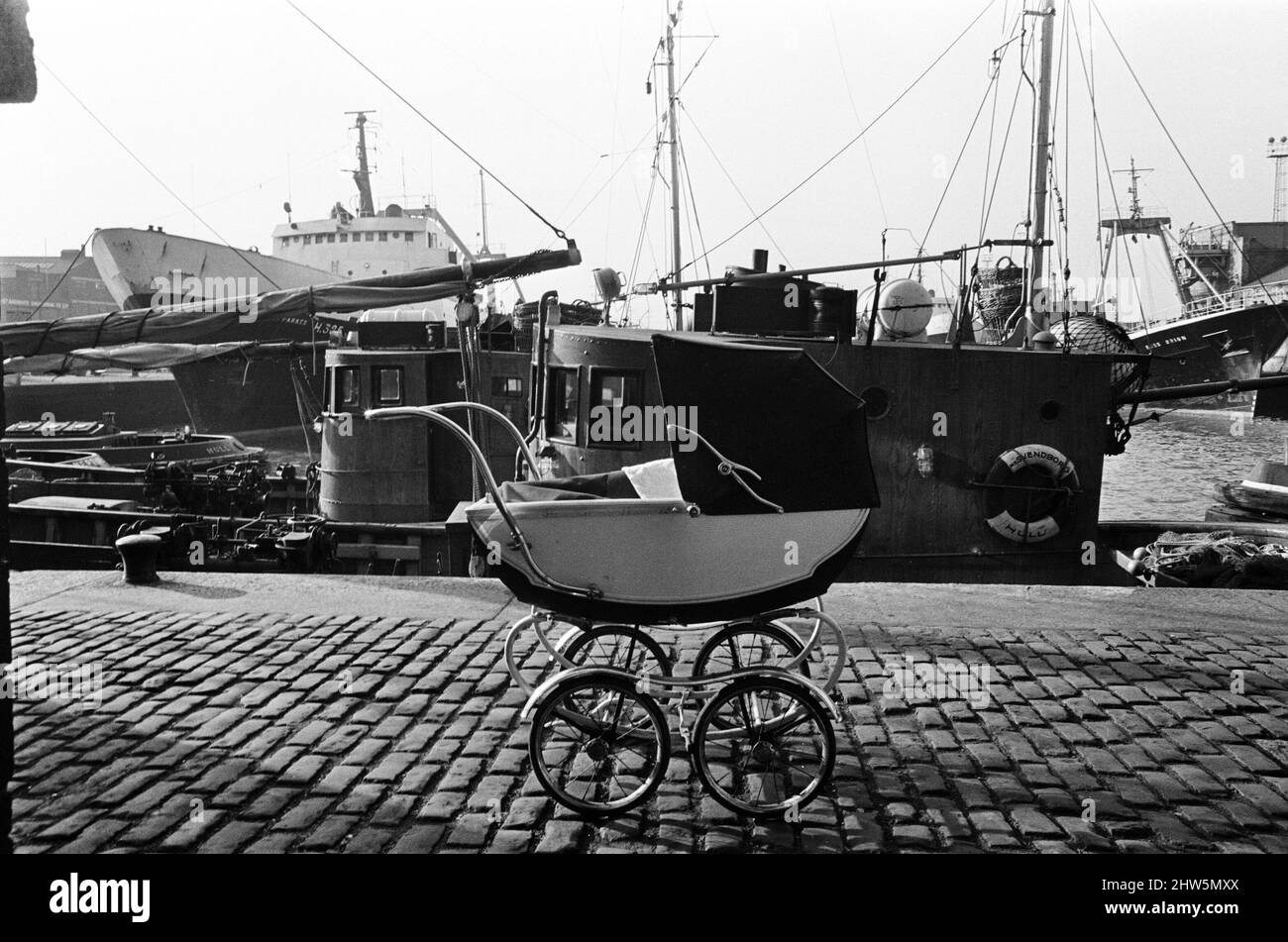 View of the fish dock with empty pram in foreground left by wife and ...