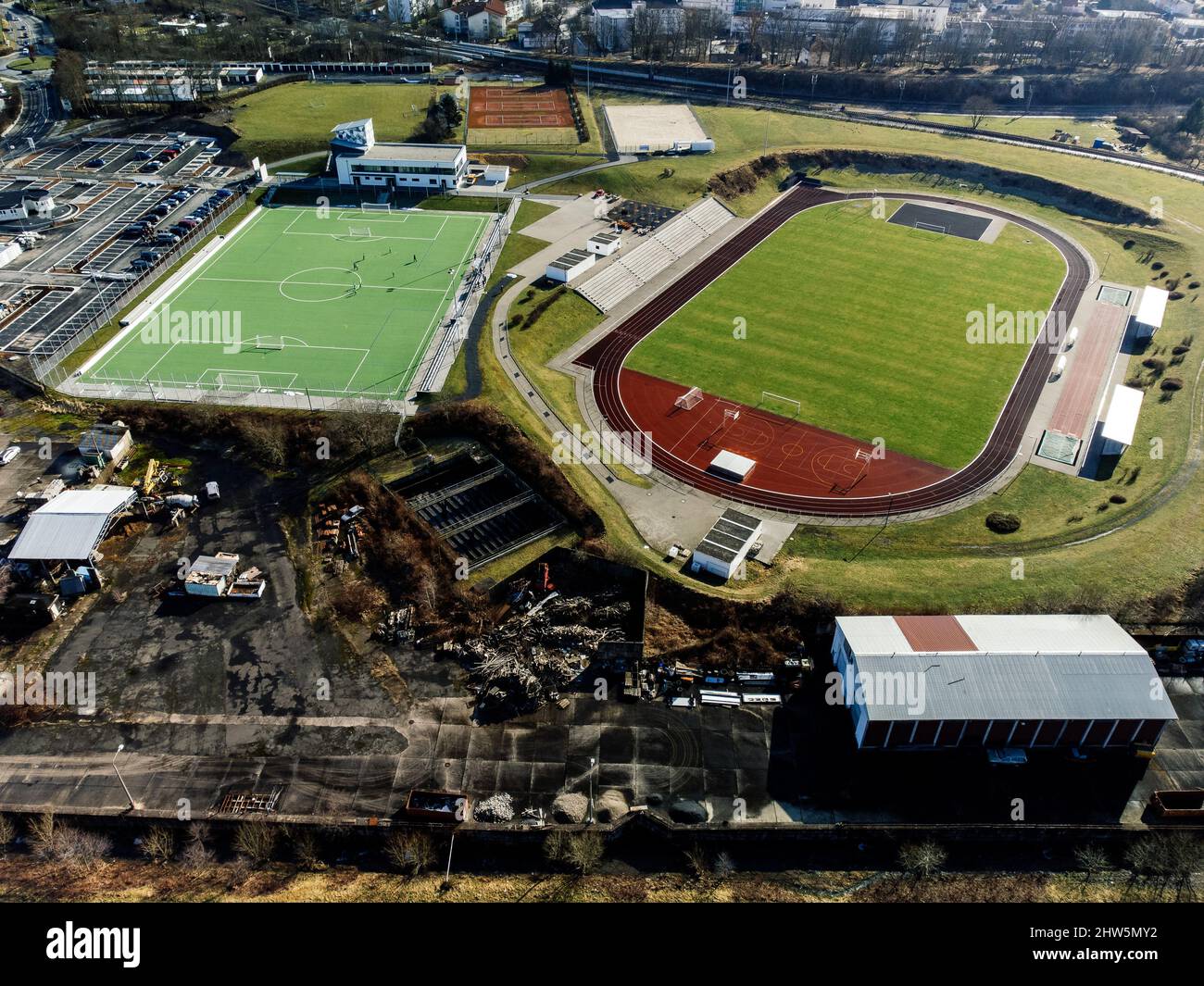 Drone shot of a football stadium and buildings in the city of Sonneberg ...