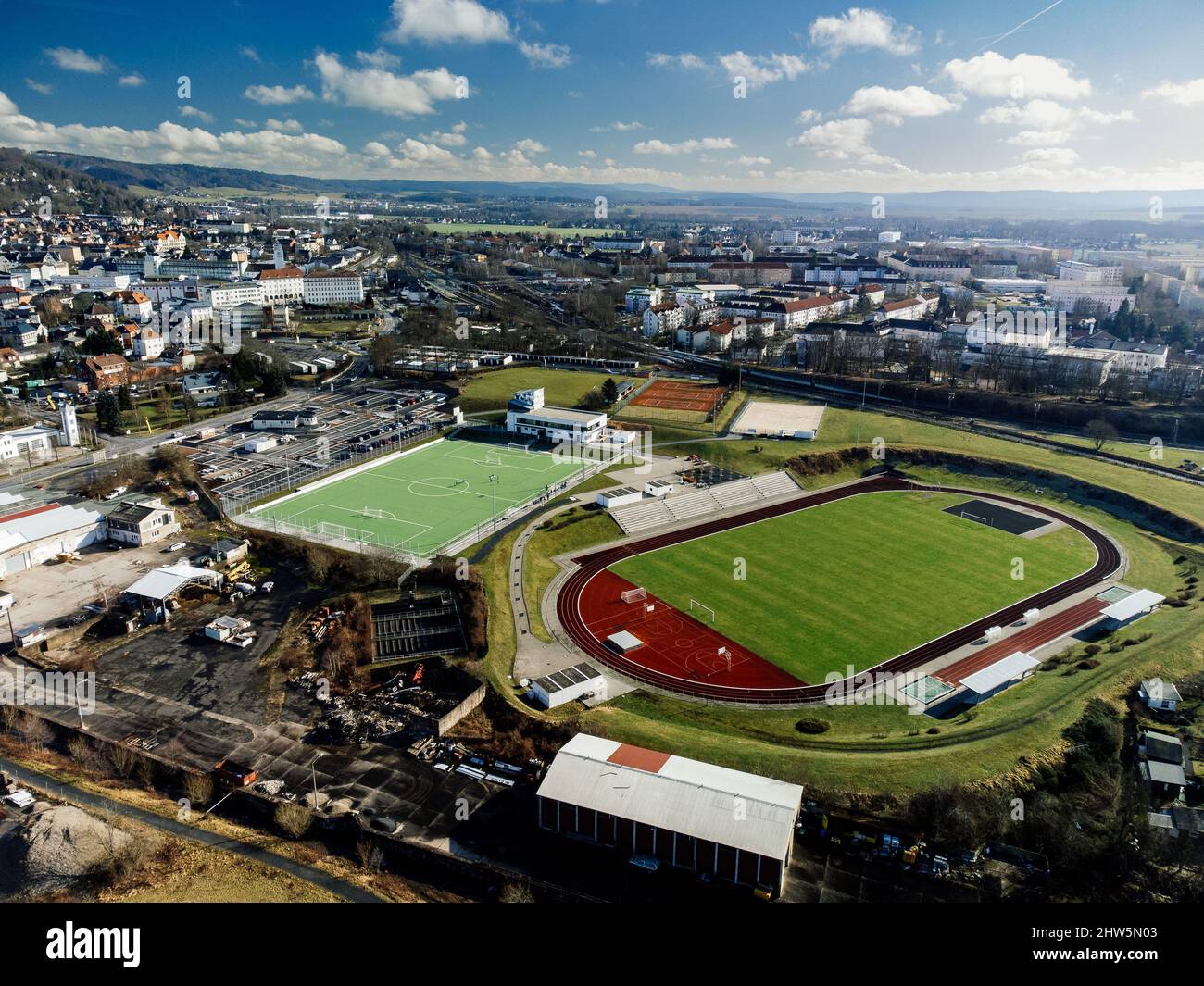 Drone shot of a football stadium and buildings in the city of Sonneberg ...