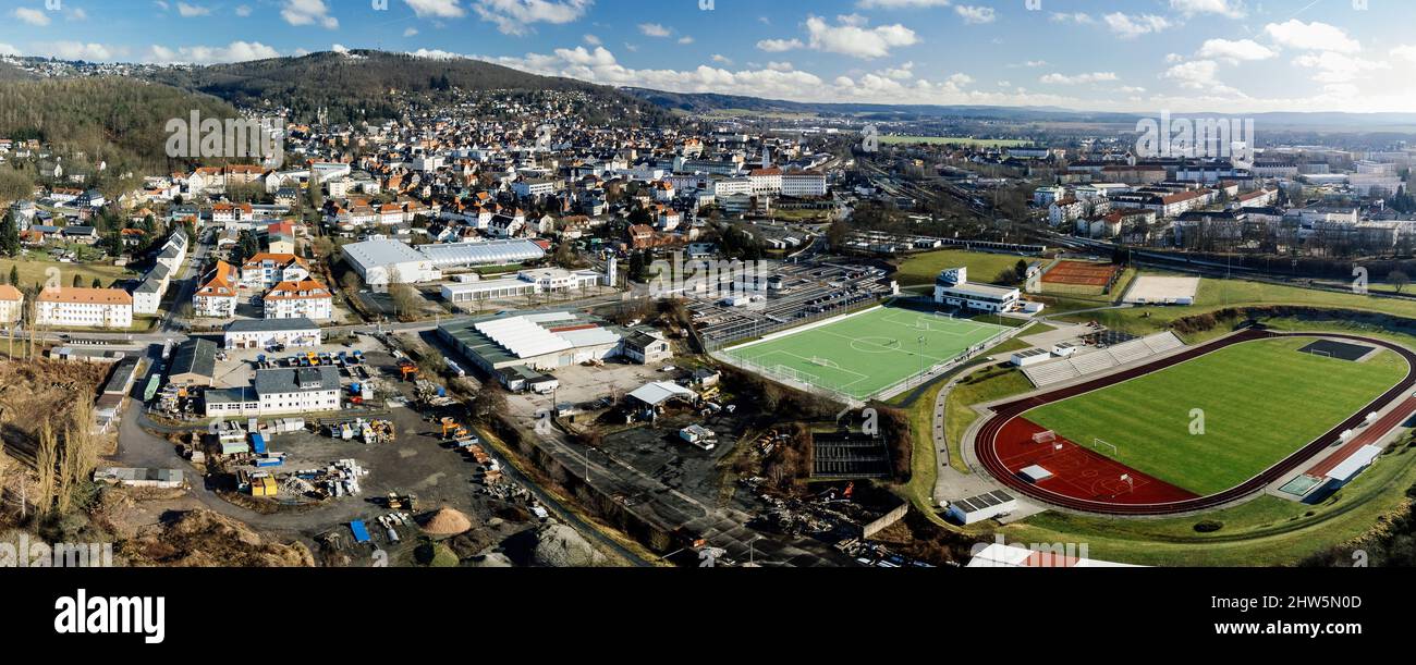 Drone shot of a football stadium and buildings in the city of Sonneberg ...