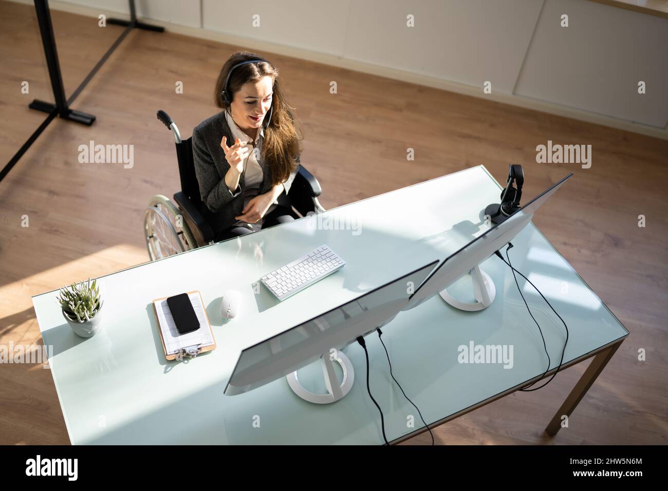 Disabled Worker In Wheelchair Working On Computer Stock Photo - Alamy
