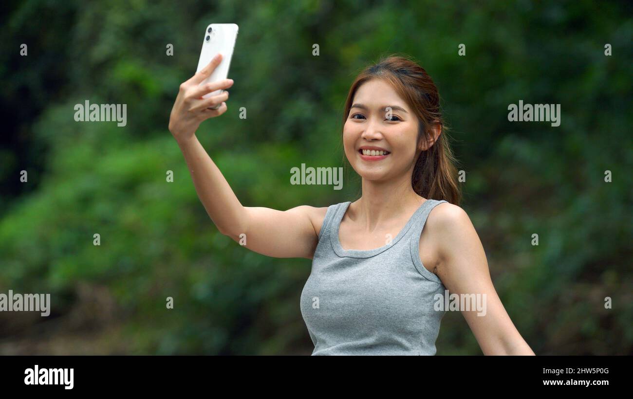 Young Southeast Asian female taking a selfie in nature Stock Photo - Alamy