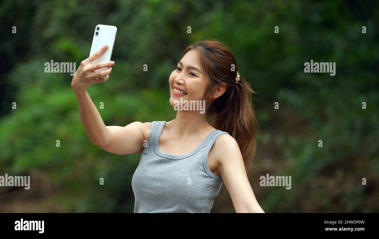 Young Southeast Asian female taking a selfie in nature Stock Photo - Alamy