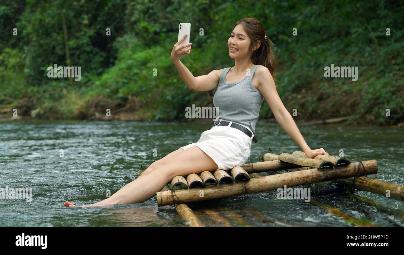 Young Southeast Asian female taking a selfie in nature Stock Photo - Alamy