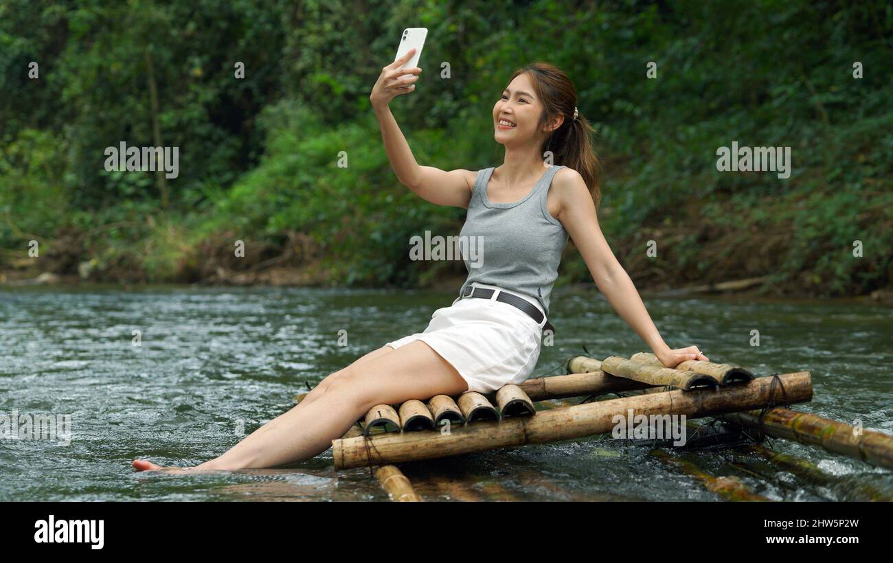 Young Southeast Asian female taking a selfie in nature Stock Photo - Alamy
