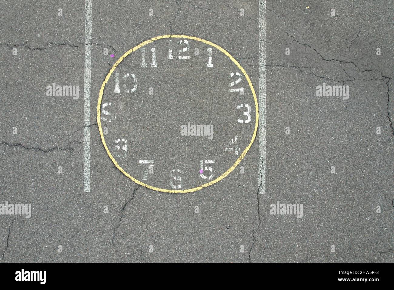 Aerial view of a clock painted on the asphalt ground Stock Photo - Alamy