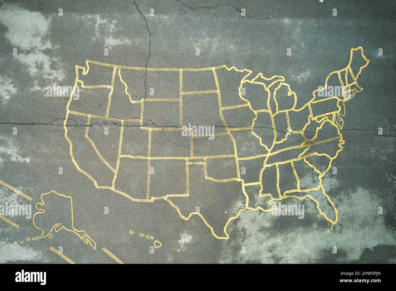 Aerial shot of the USA map painted on cracked asphalt ground Stock ...