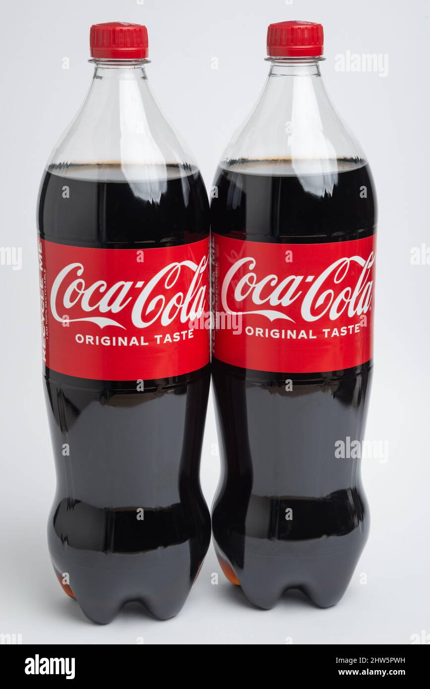 Vertical shot of Coca Cola plastic bottles isolated on white background ...