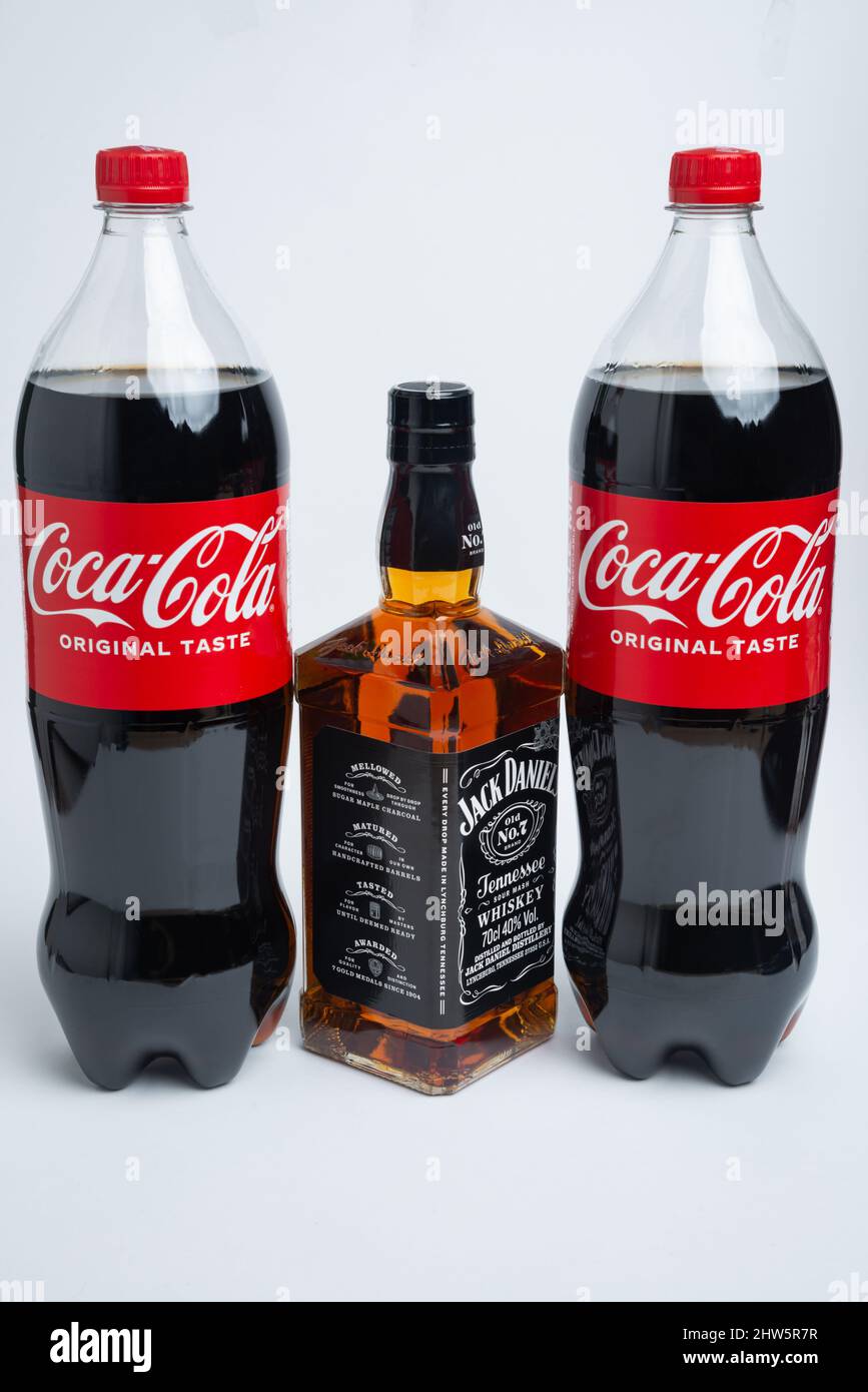 Vertical shot of Coca Cola plastic bottles and Jack Daniel whiskey ...