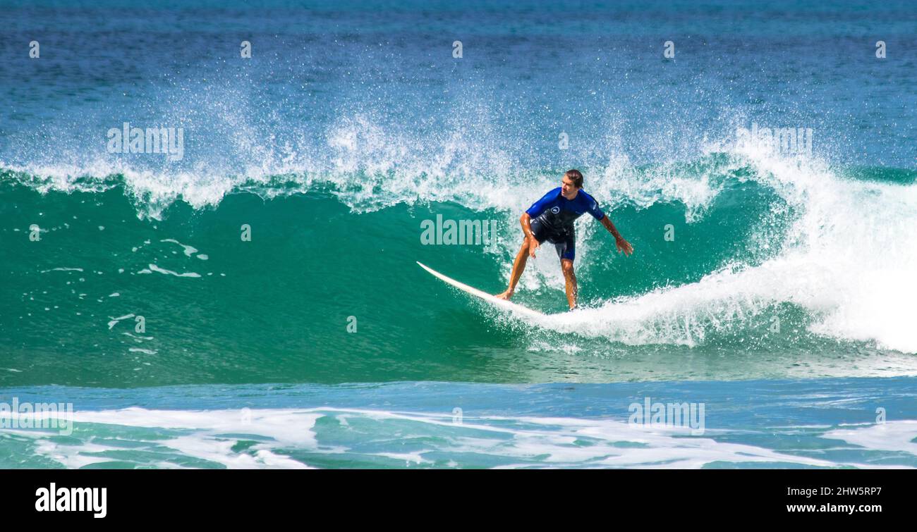 Surfer on blue ocean wave at daytime Stock Photo - Alamy