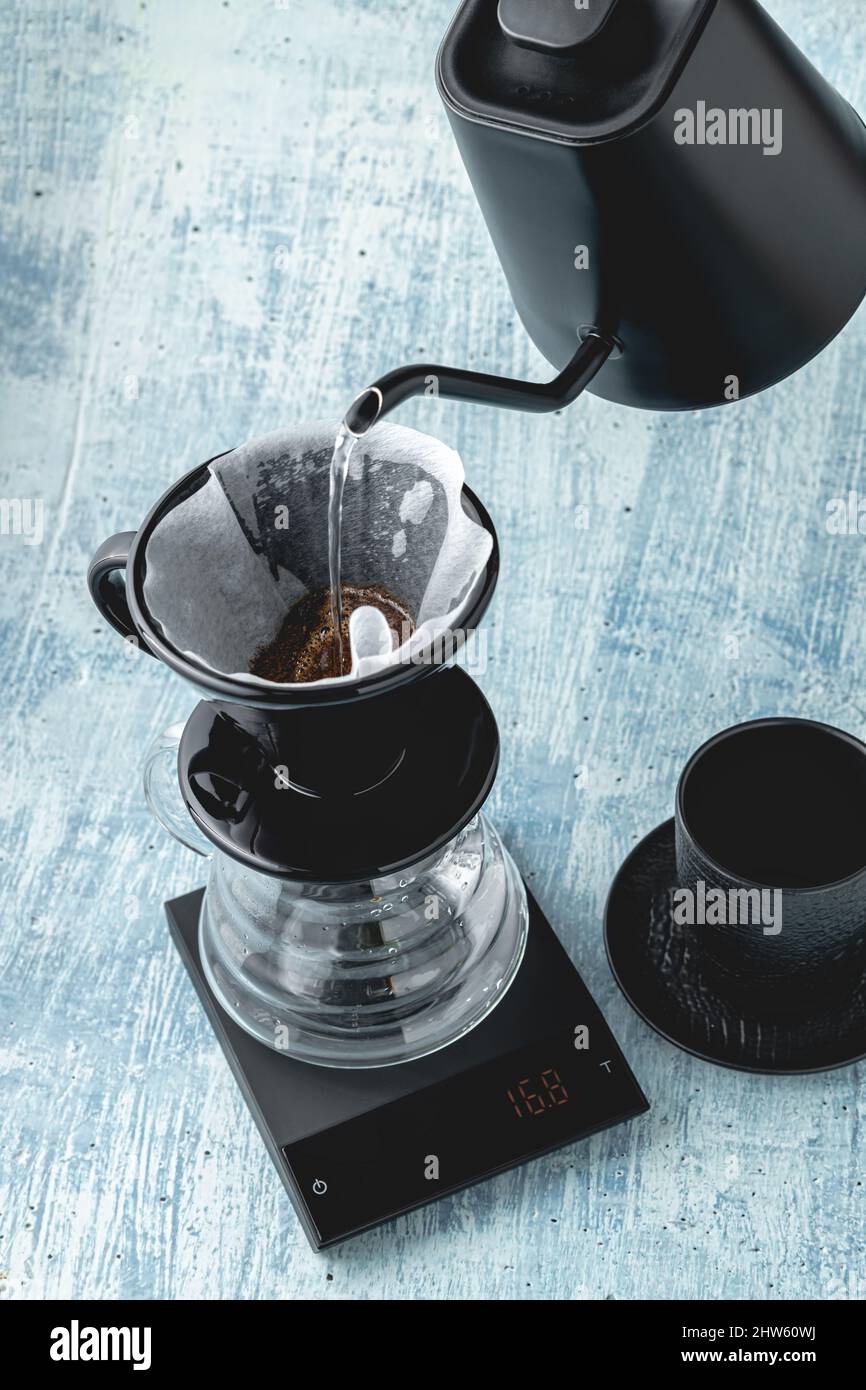 Professional barista brews coffee with pour over method. Alternative ...
