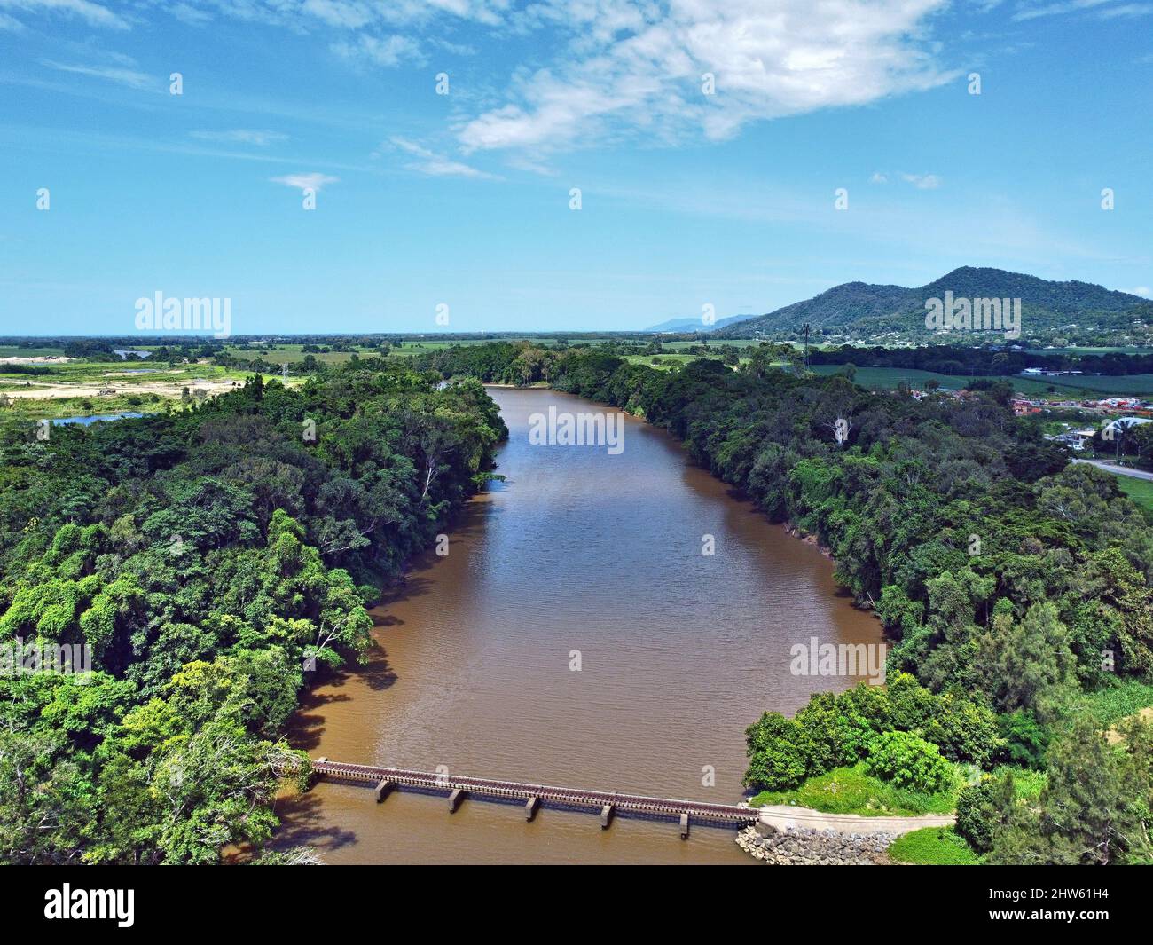 Aerial view of train bridge of brown river in Far North Qwueensland ...