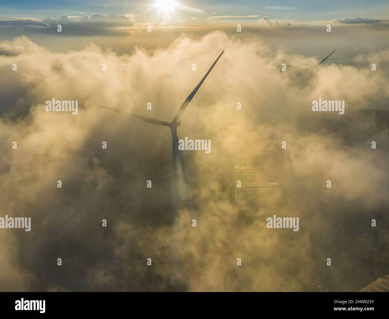 Aerial view of windmill or wind farm in fog at Cau Dat town, Da Lat ...