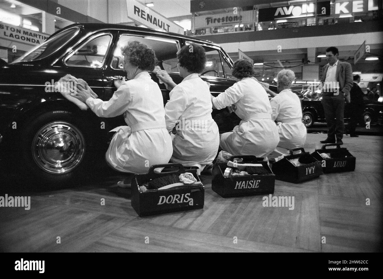 Four cleaning ladies polishing up one of the motors at the Earls Court ...