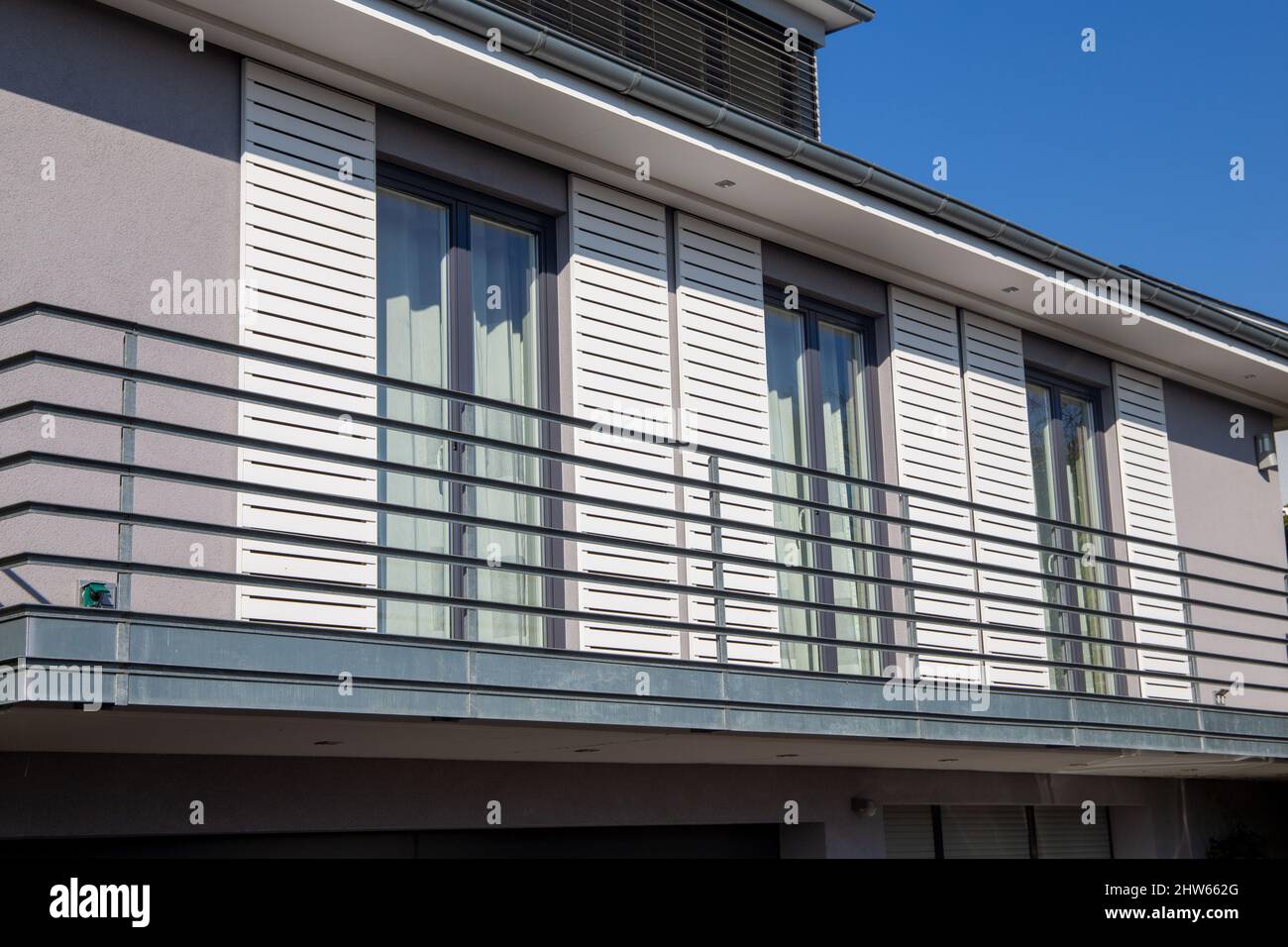 Windows with modern sliding shutters Stock Photo - Alamy