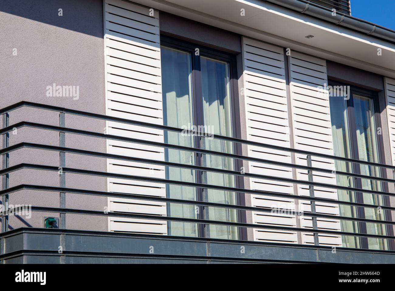 Windows with modern sliding shutters Stock Photo - Alamy