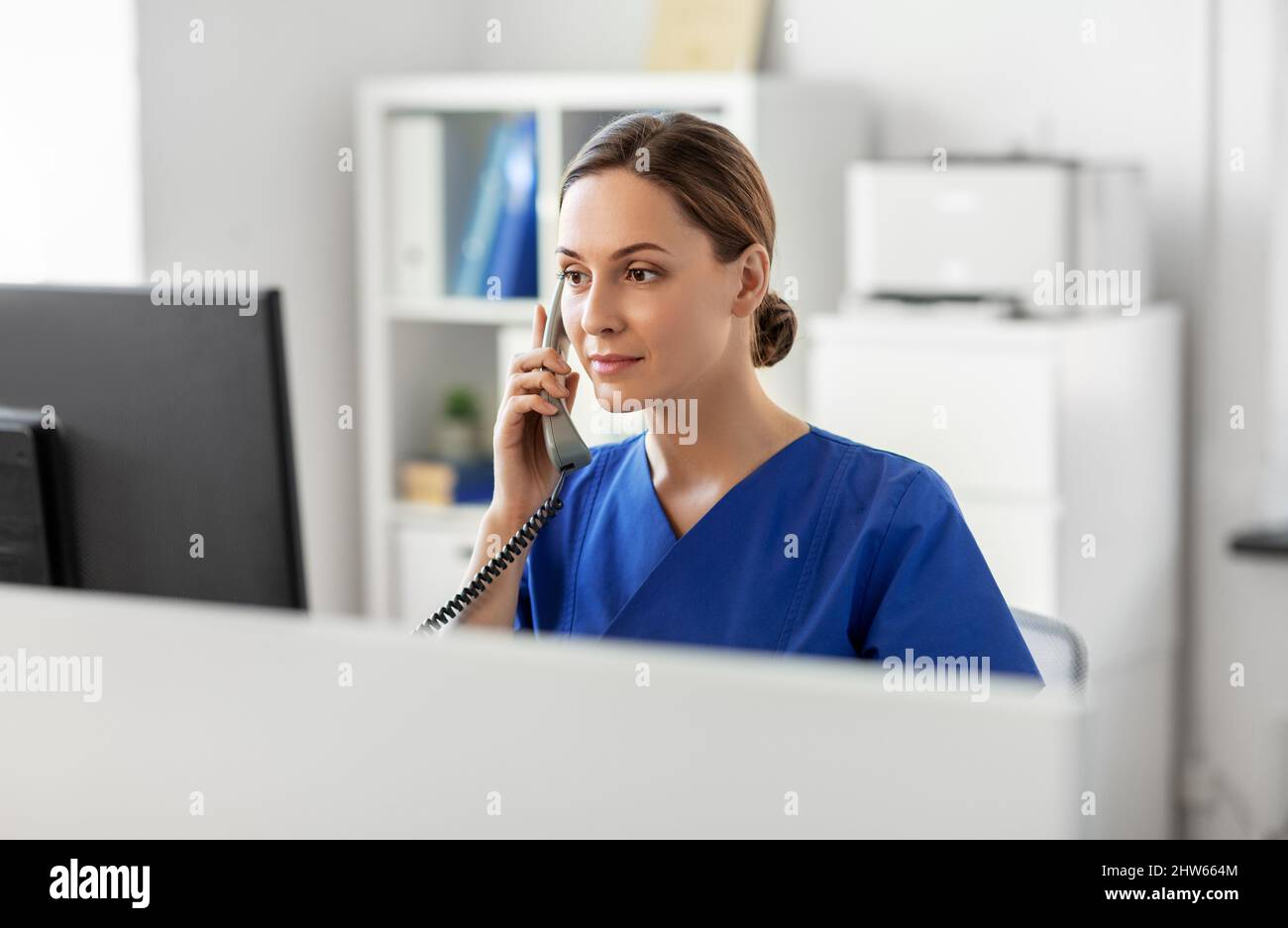 doctor with computer calling on phone at hospital Stock Photo - Alamy