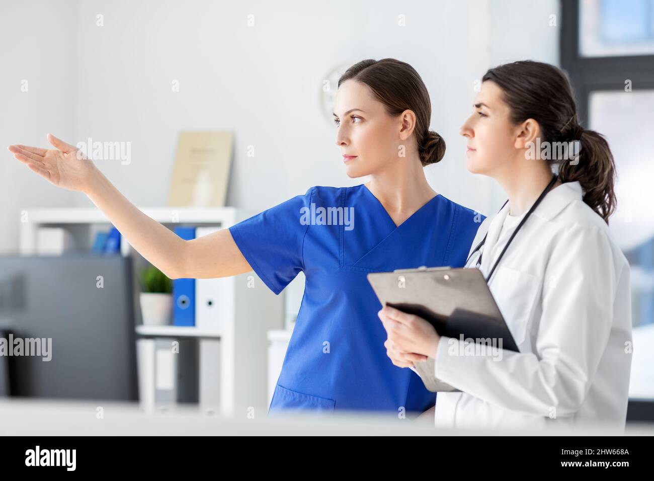 nurse showing something to doctor at hospital Stock Photo - Alamy