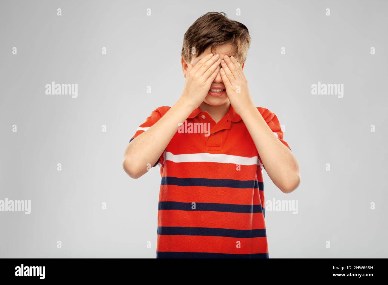 scared boy closing eyes with hands Stock Photo - Alamy